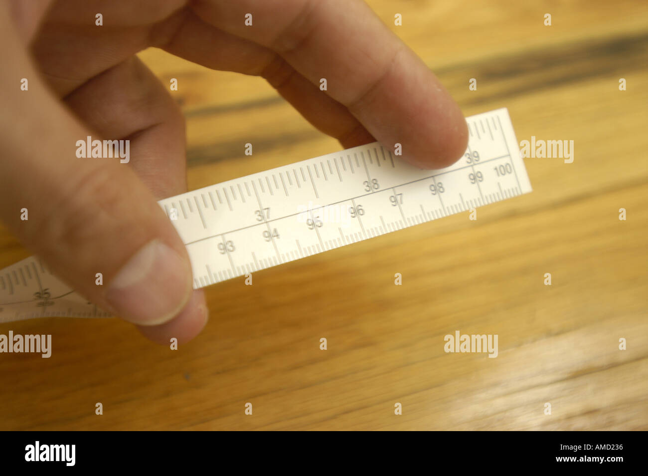 Hand fingers holding a white measuring tape Stock Photo - Alamy