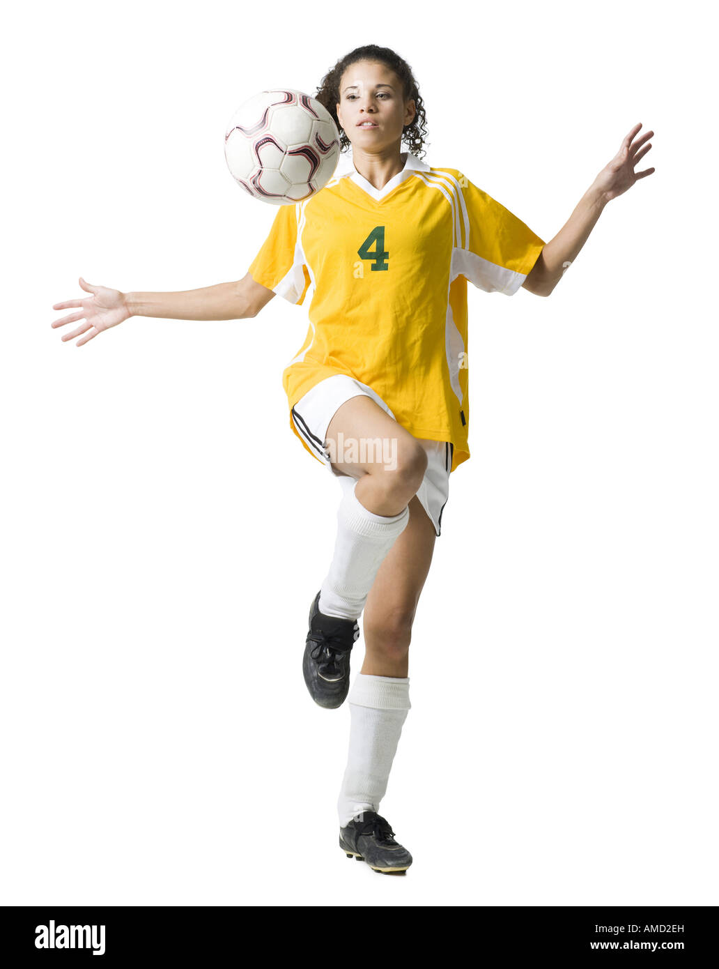 Teenage girl kicking soccer ball Stock Photo - Alamy
