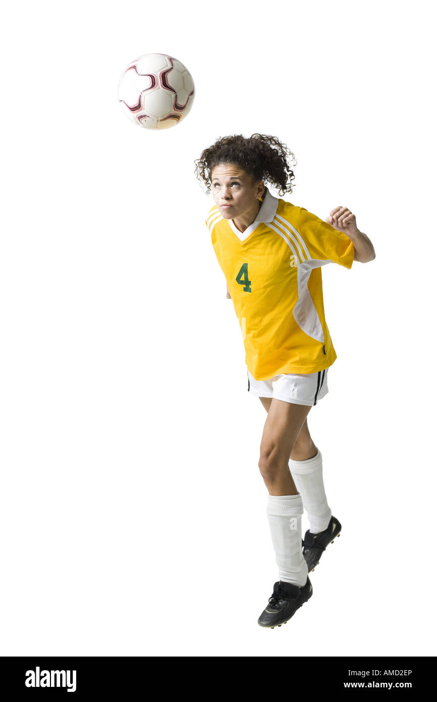 Teenage girl heading soccer ball Stock Photo - Alamy