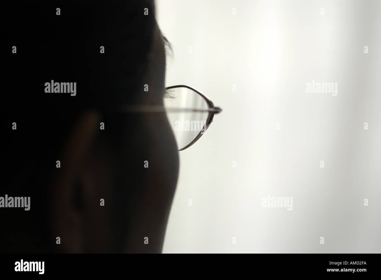 Very close up side angle face with glasses on left looking right bright ...