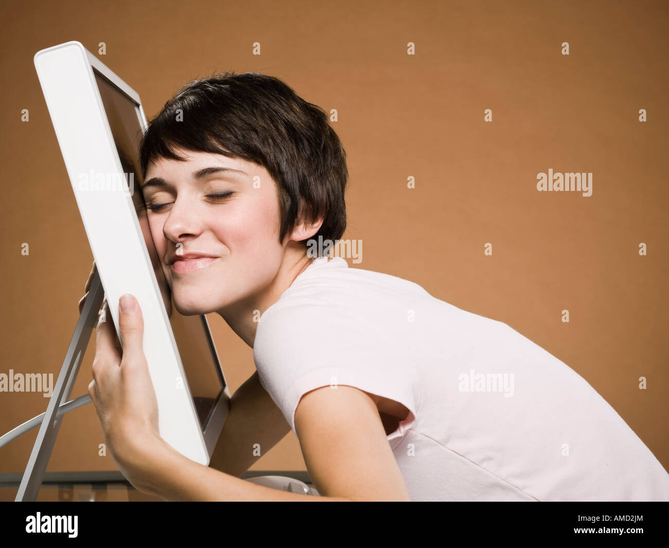 Woman hugging computer monitor Stock Photo - Alamy