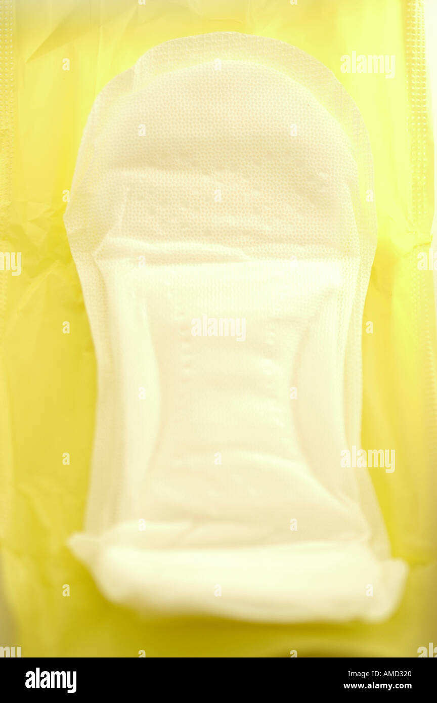 Open maxi pad lying horizontal on bright yellow background Vertical ...