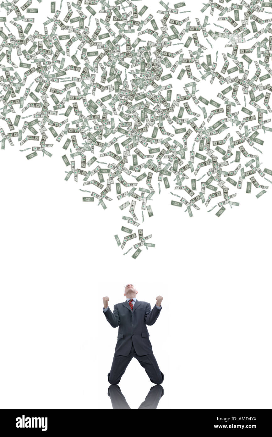 Young businessman with a lot of falling dollars Stock Photo - Alamy