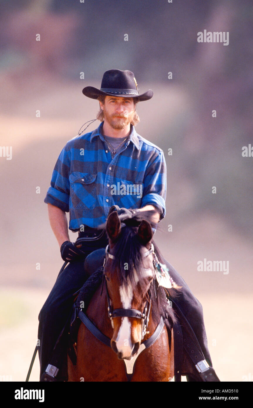 Man on horseback riding western style Stock Photo - Alamy