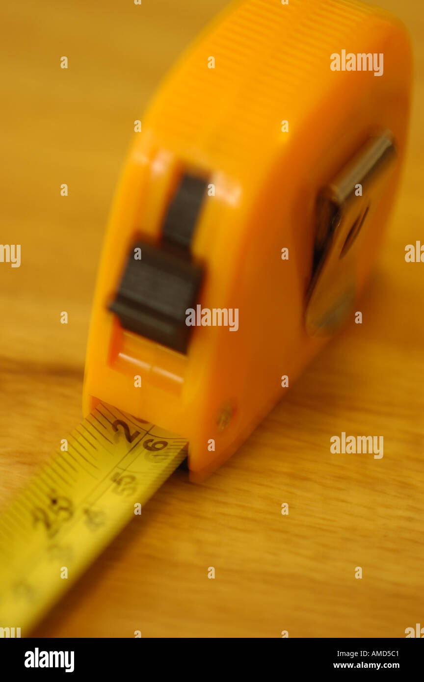 Extended measuring tape yellow Stock Photo - Alamy