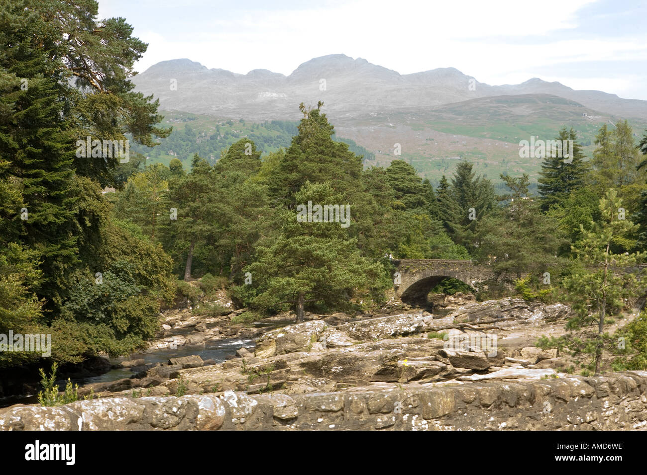 Old stone bridge at the Falls of Dochart in the village of Killin in ...