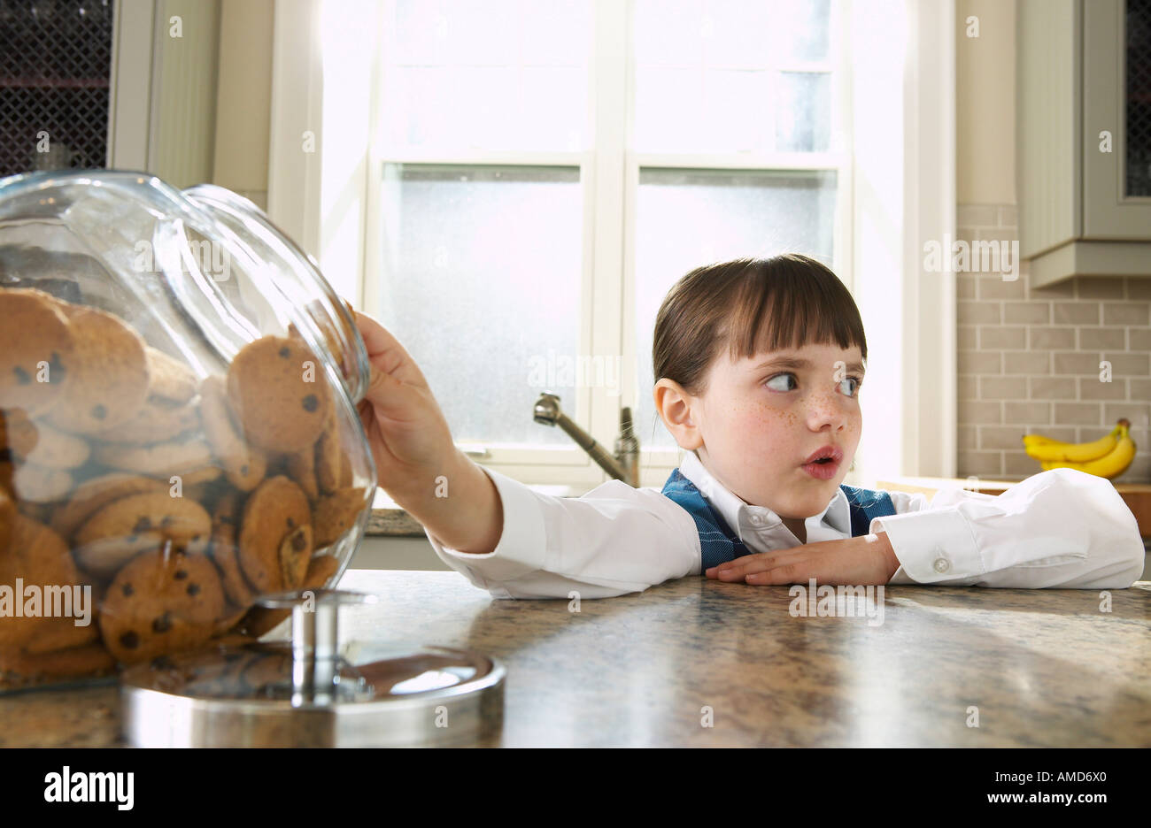 Child stealing biscuit hi-res stock photography and images - Alamy