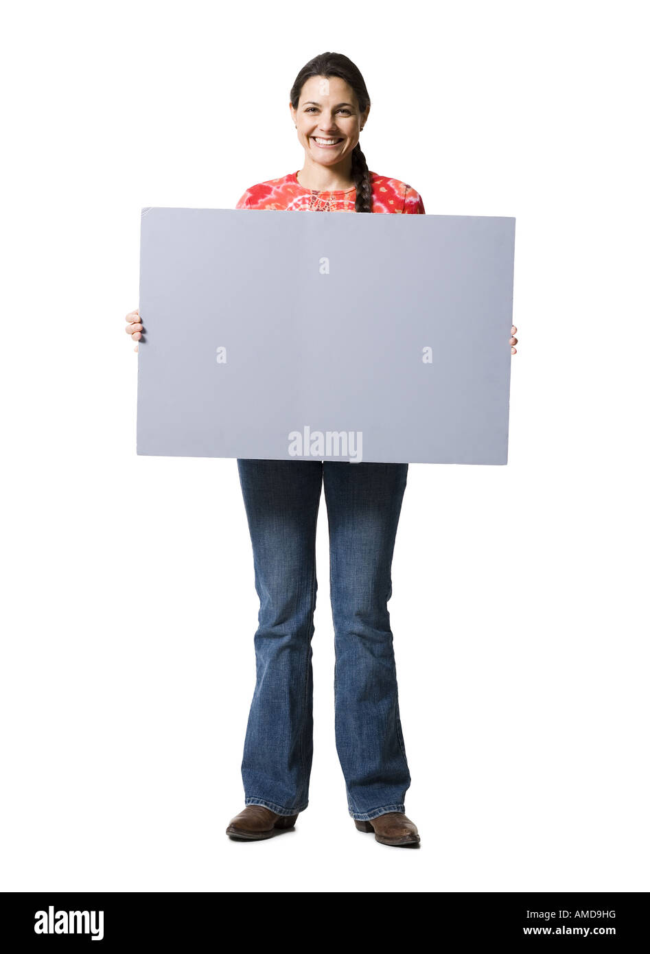 Woman standing with blank sign smiling Stock Photo - Alamy