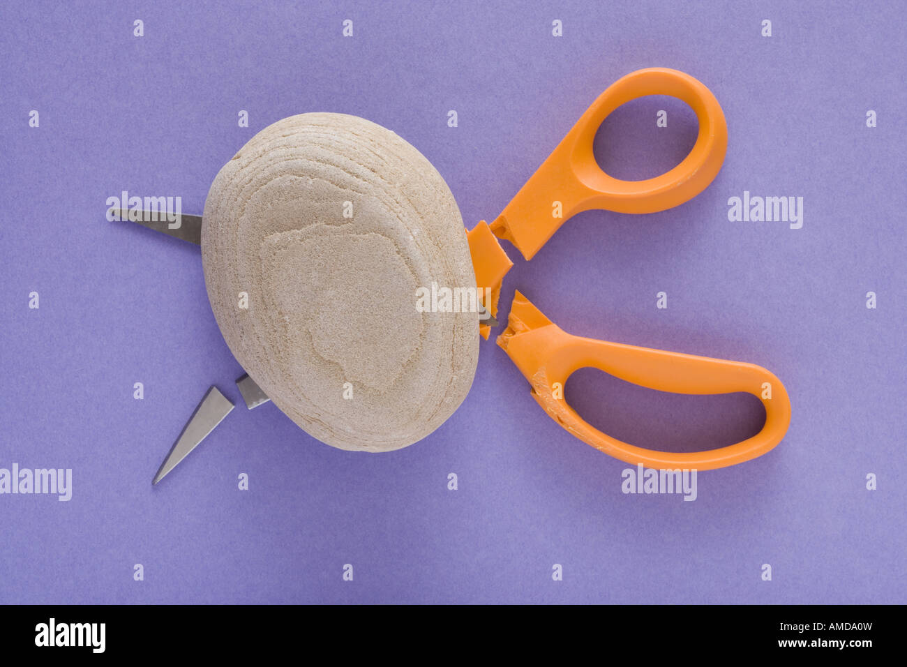 Rock with broken scissors Stock Photo - Alamy