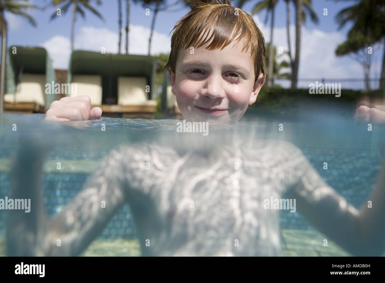 Boy in outdoor pool smiling Stock Photo - Alamy