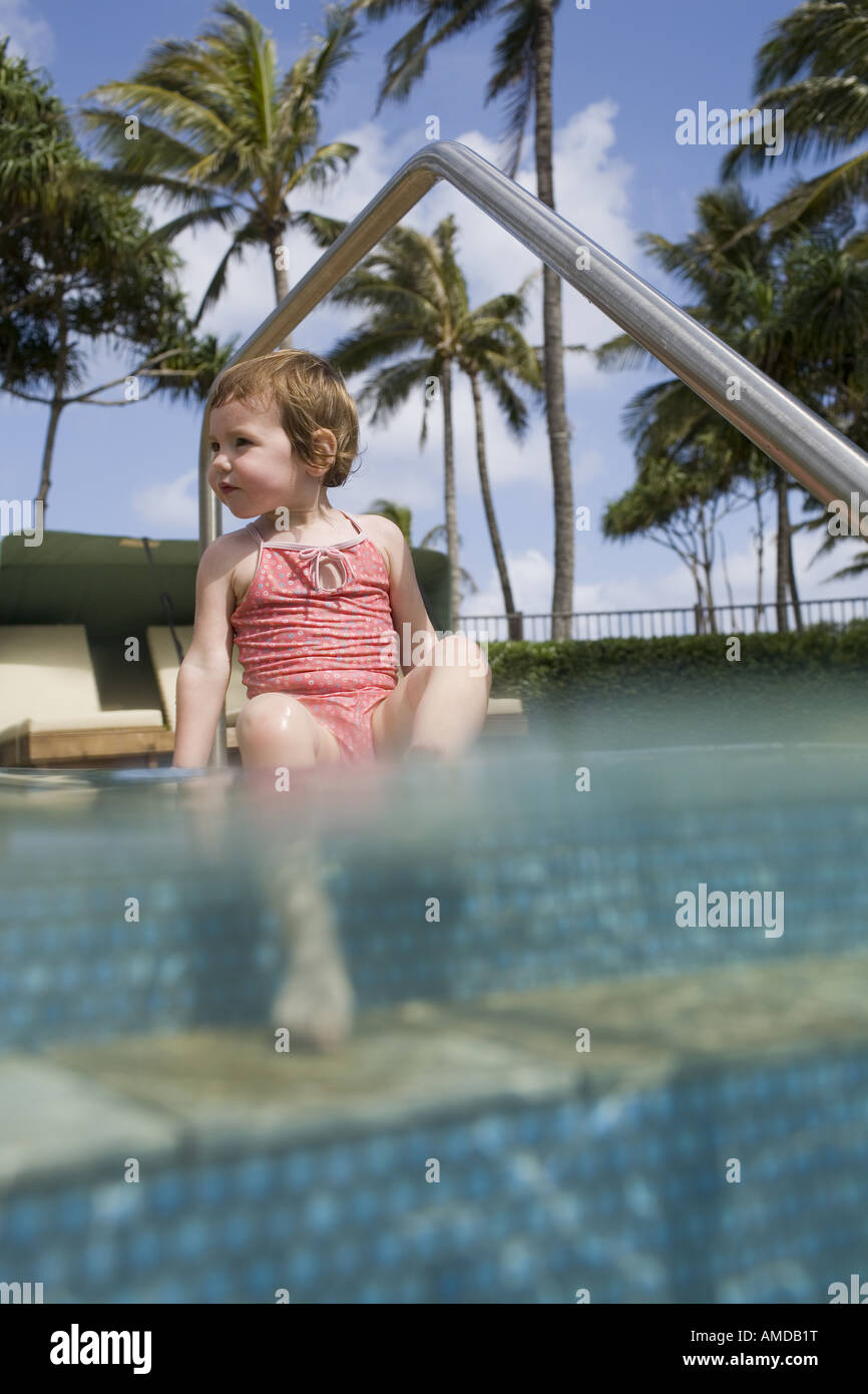 Girl sitting in outdoor pool Stock Photo - Alamy