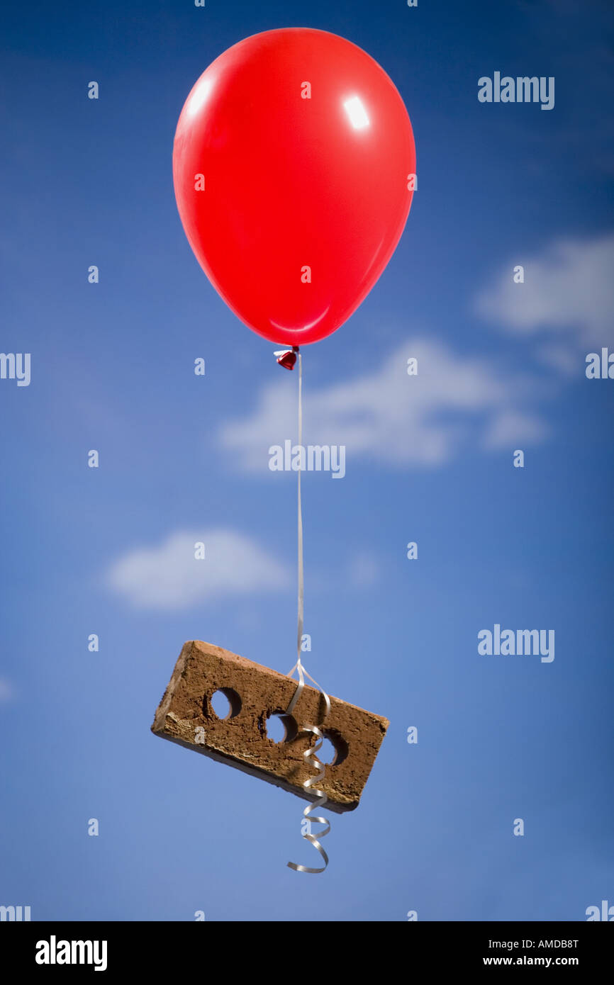 Helium balloon lifting brick outdoors Stock Photo - Alamy
