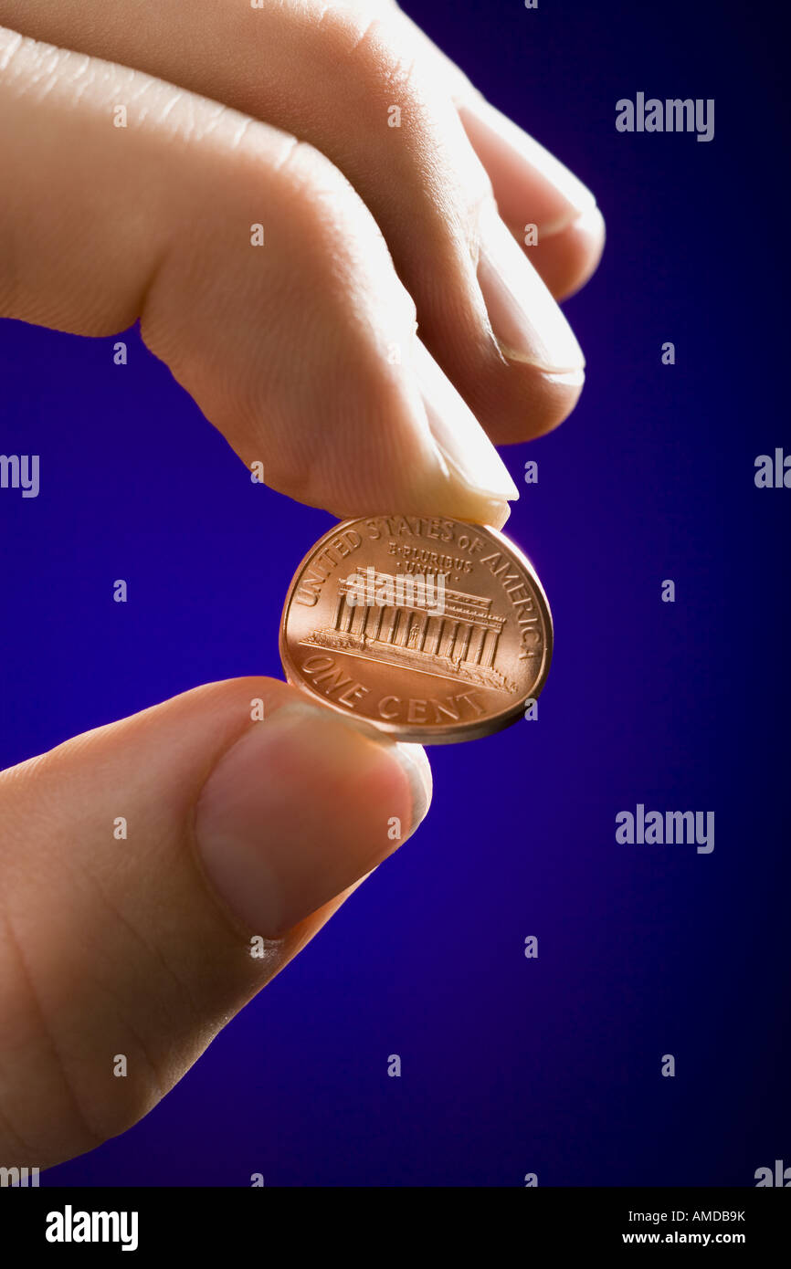 Detailed view of male hand bending penny Stock Photo - Alamy