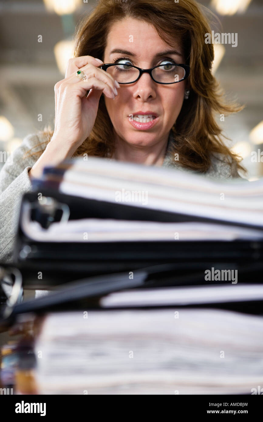 View of a frustrated woman looking at files Stock Photo - Alamy