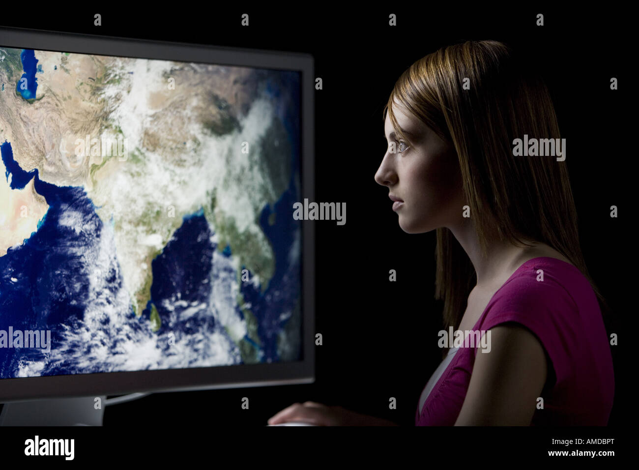 Girl looking at satellite earth image on computer monitor Stock Photo ...