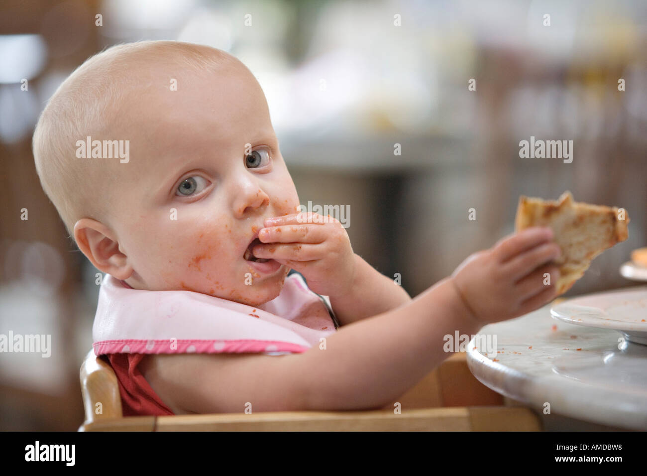 Baby eating in restaurant Stock Photo - Alamy