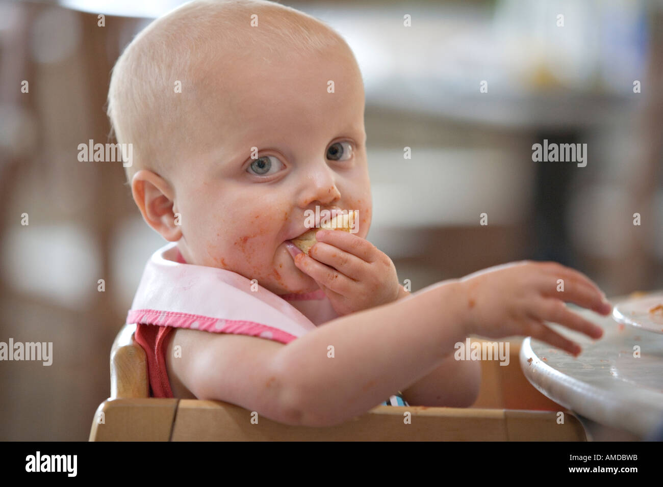 Baby eating in restaurant Stock Photo - Alamy