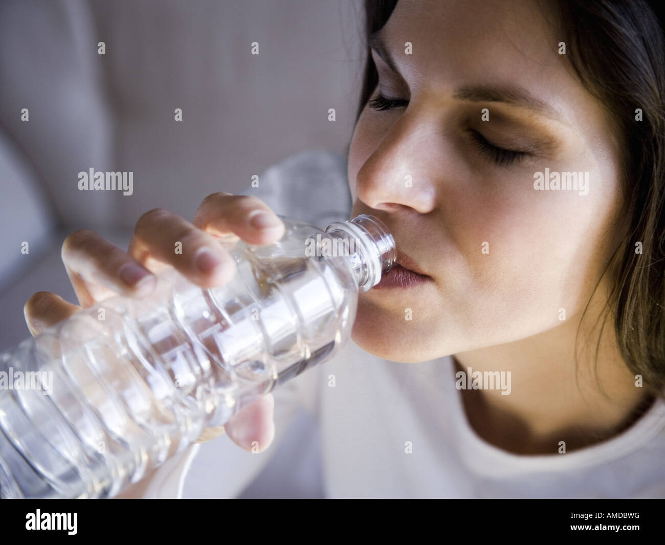Woman drinking bottled water Stock Photo - Alamy