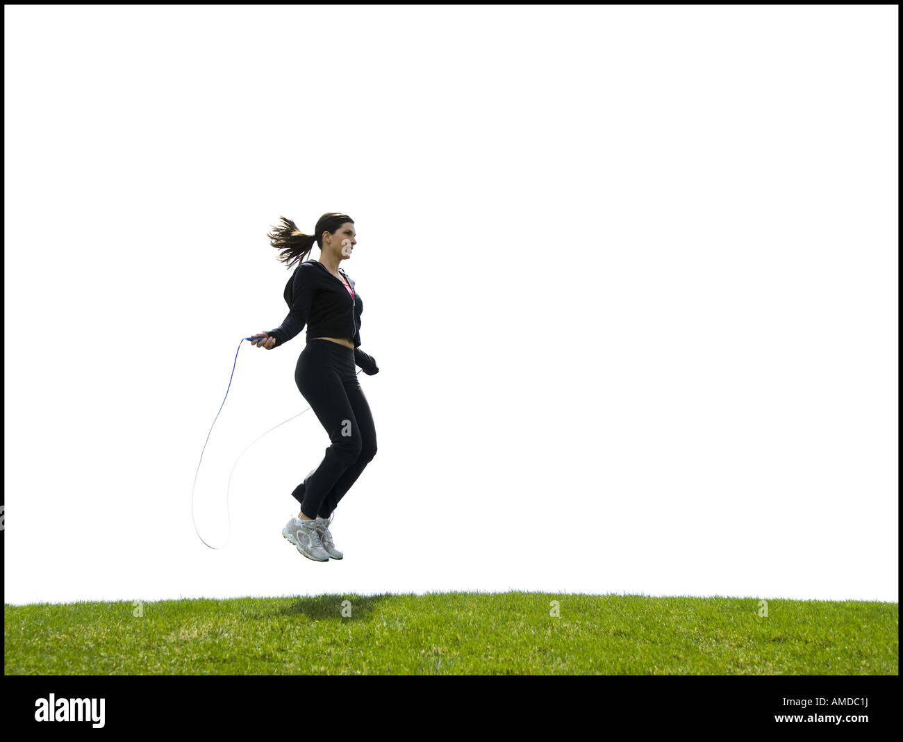 Woman skipping rope outdoors Stock Photo - Alamy