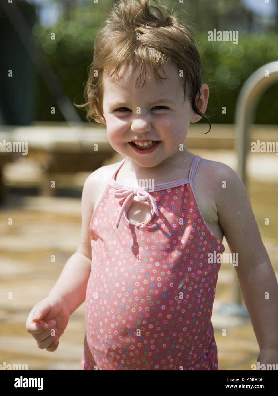 Baby girl standing and smiling outdoors Stock Photo - Alamy
