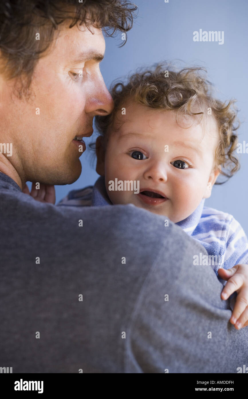 Man holding baby boy looking frightened Stock Photo - Alamy