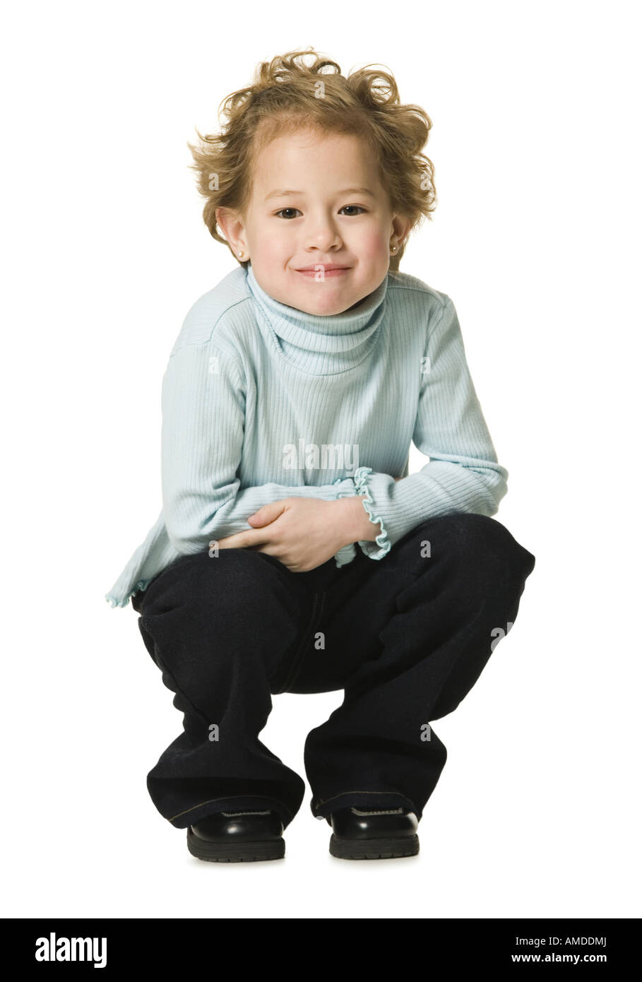Girl crouching and smiling Stock Photo - Alamy