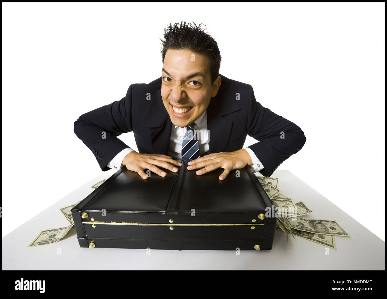 Young businessman with banknotes falling out of briefcase Stock Photo ...