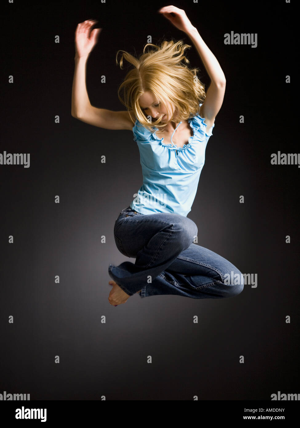 Woman jumping with arms up Stock Photo - Alamy