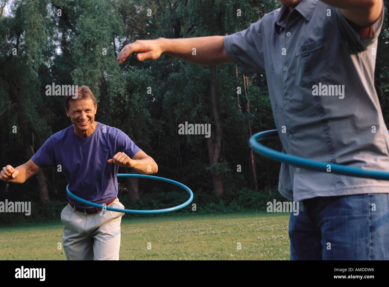 Men Using Hula Hoops Outdoors Stock Photo - Alamy