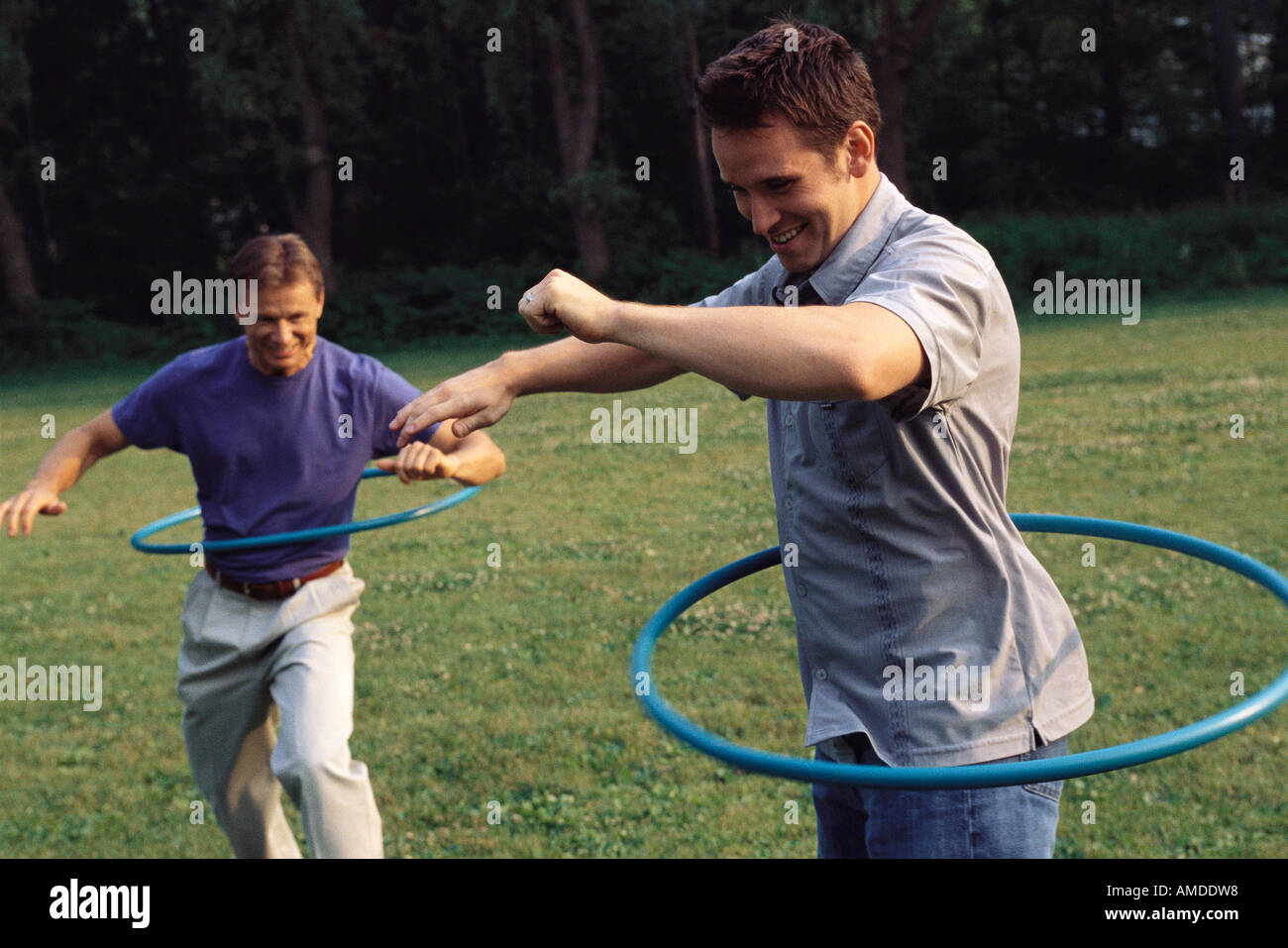 Men Using Hula Hoops Outdoors Stock Photo - Alamy