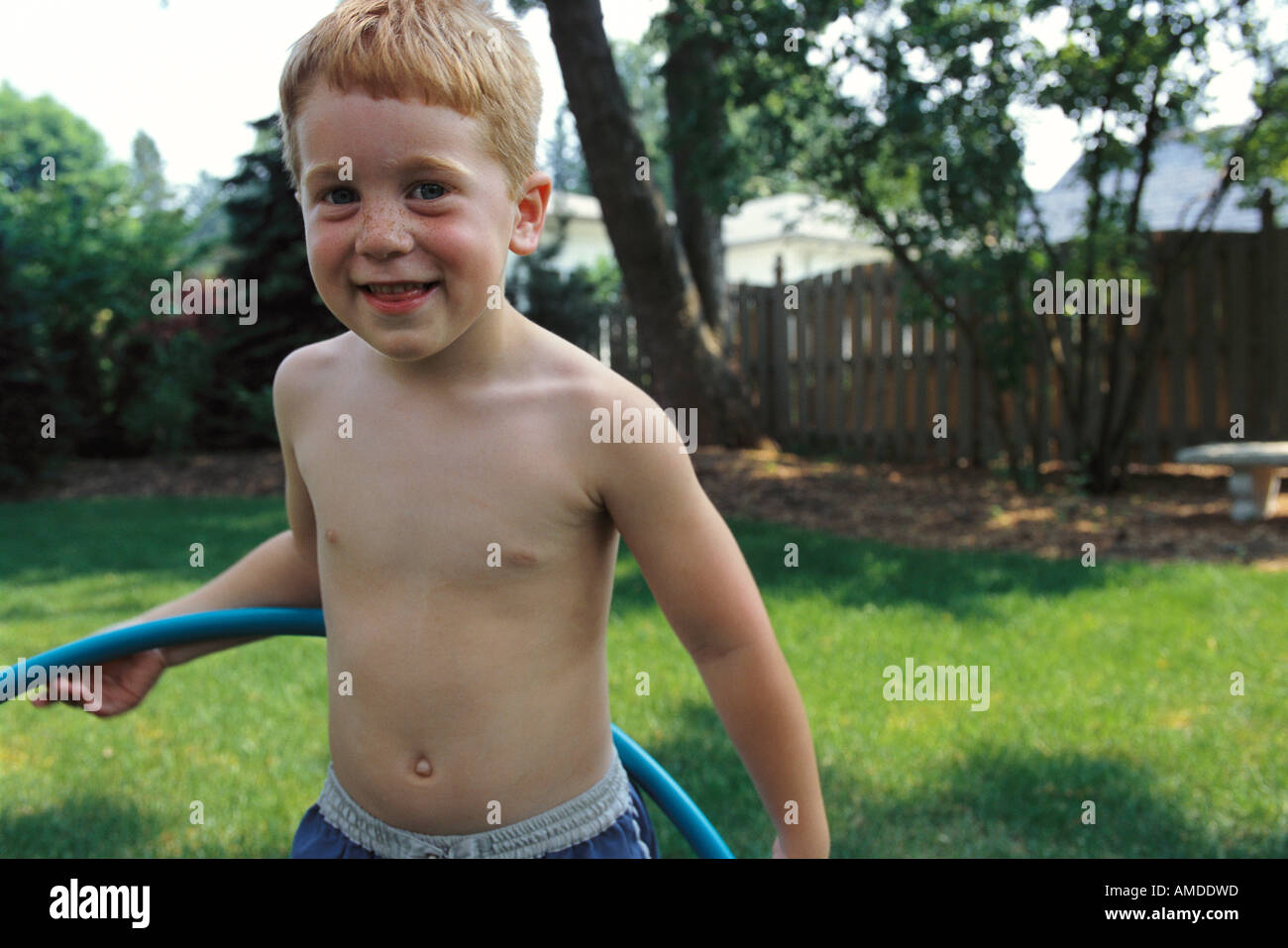 Boy playing hula hoop garden hi-res stock photography and images - Alamy