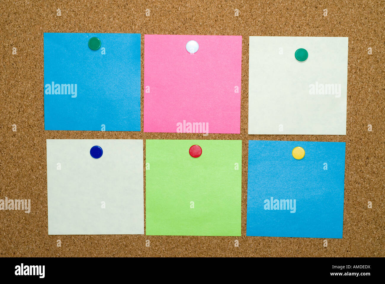 A montage of colored sticky notes on a cork message board are open to ...