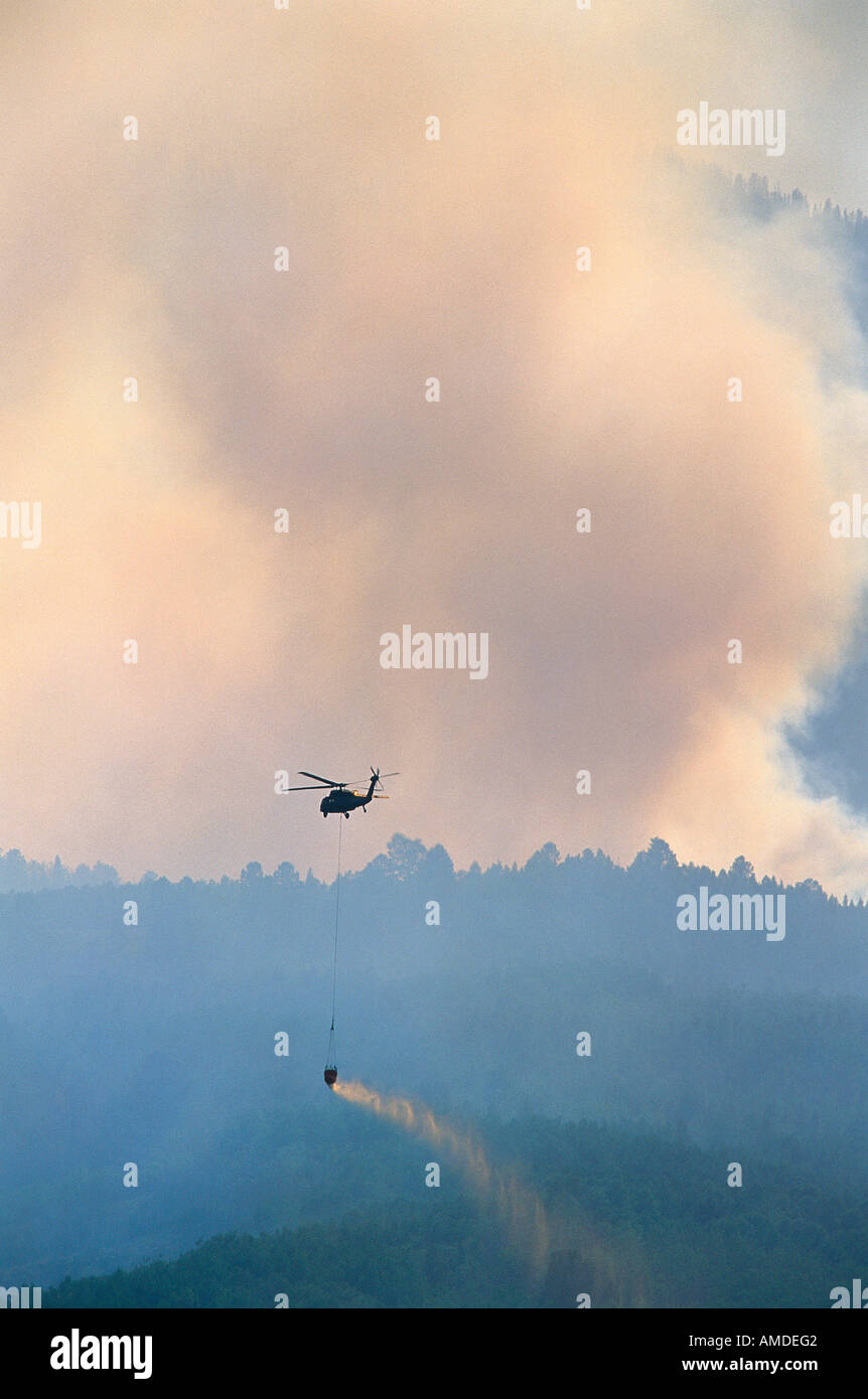 Smoke from Forest Fire with Fire Fighting Helicopter Stock Photo - Alamy