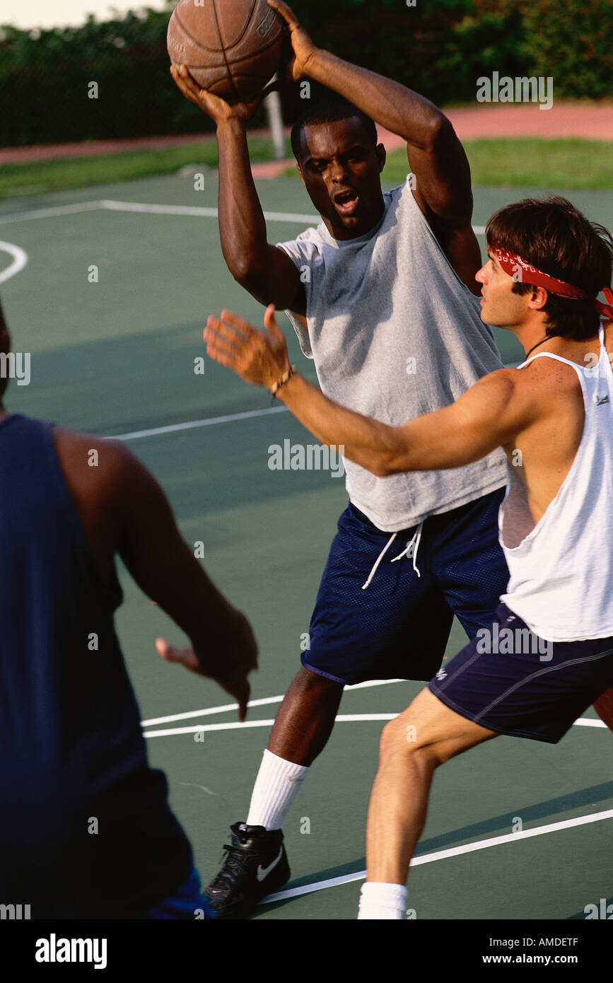 Three Men Playing Basketball Outdoors Stock Photo - Alamy