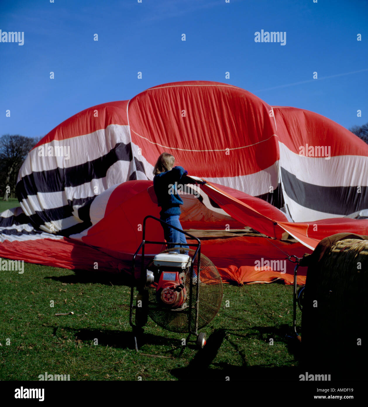 Using a fan to blow air into a hot air balloon, near Grange over Sands ...