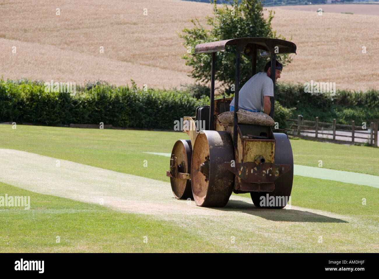 Mechanical roller irons out any bumps on the cricket pitch and wicket ...