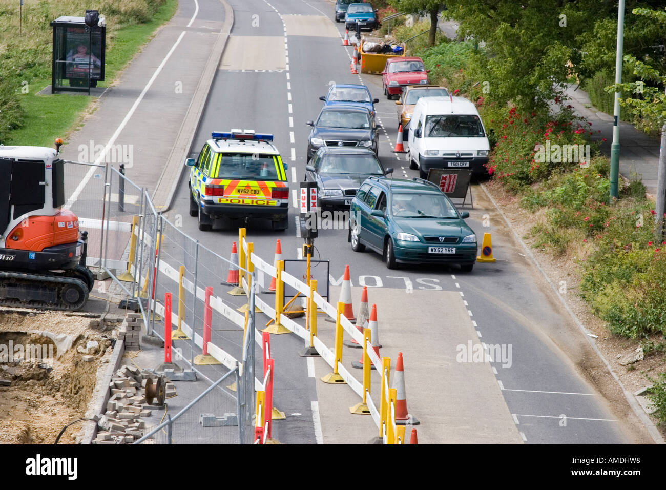 A police land rover races to an emergency through roadworks and traffic ...