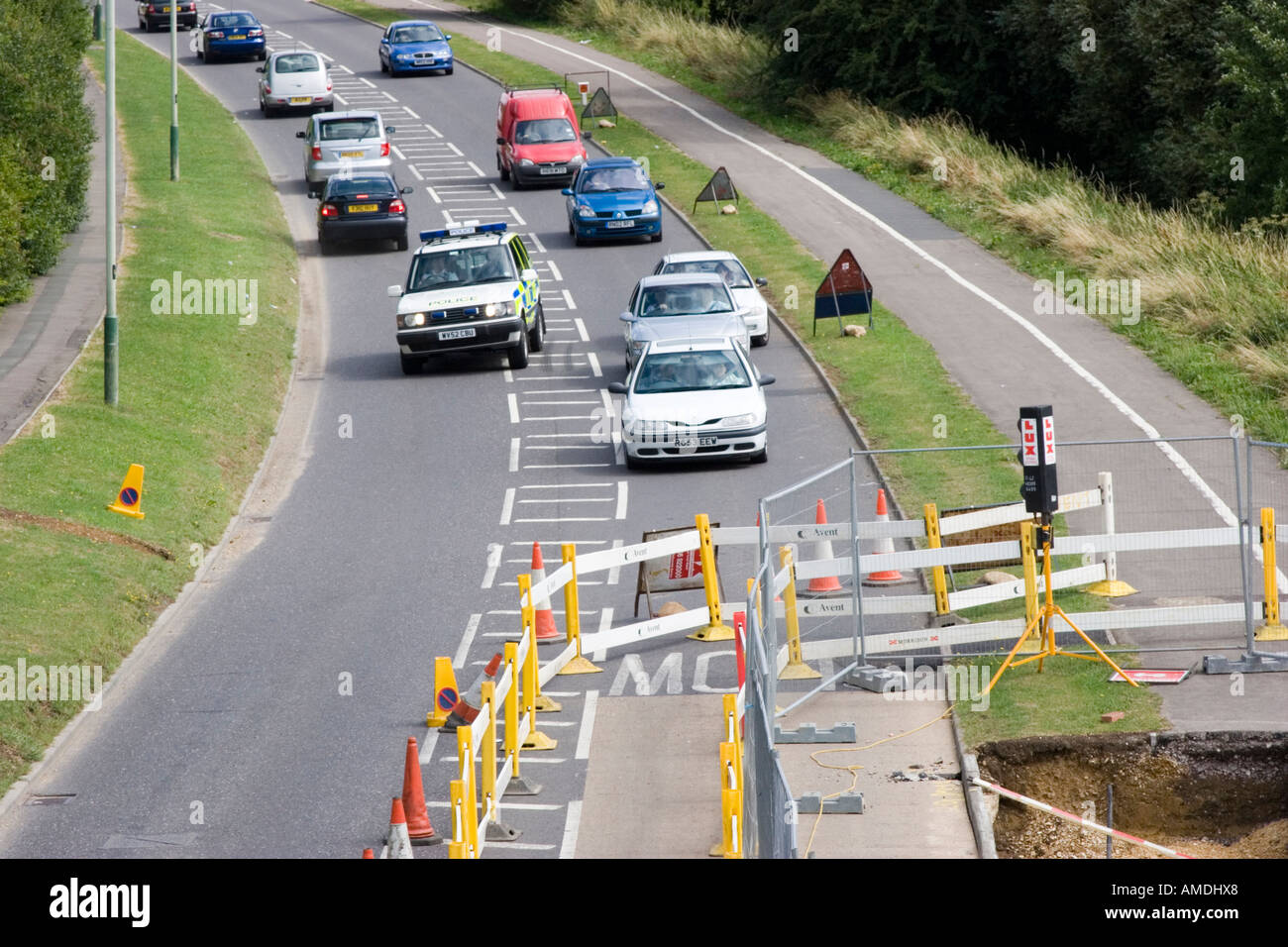 A police land rover races to an emergency through roadworks and traffic ...