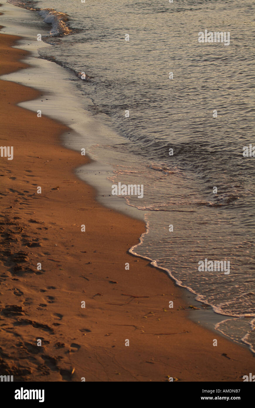 Ocean waves washing up on the beach at dusk Stock Photo - Alamy