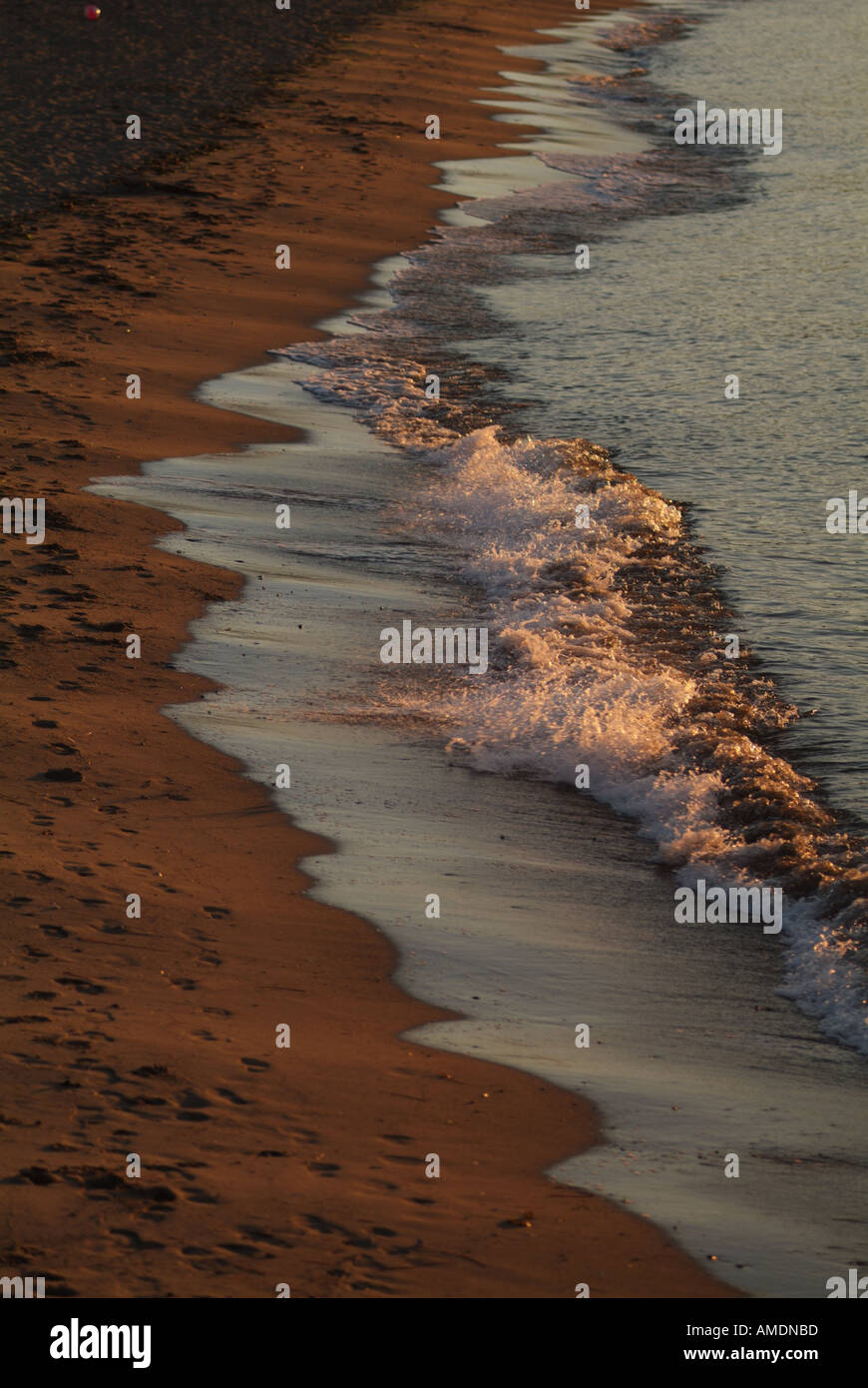 Ocean waves washing up on the beach at dusk Stock Photo - Alamy