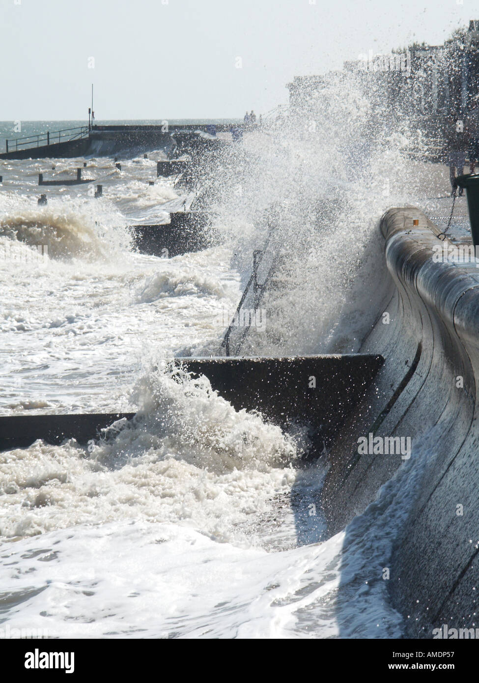 Waves crashing into reinforced concrete flood defences along the Essex ...