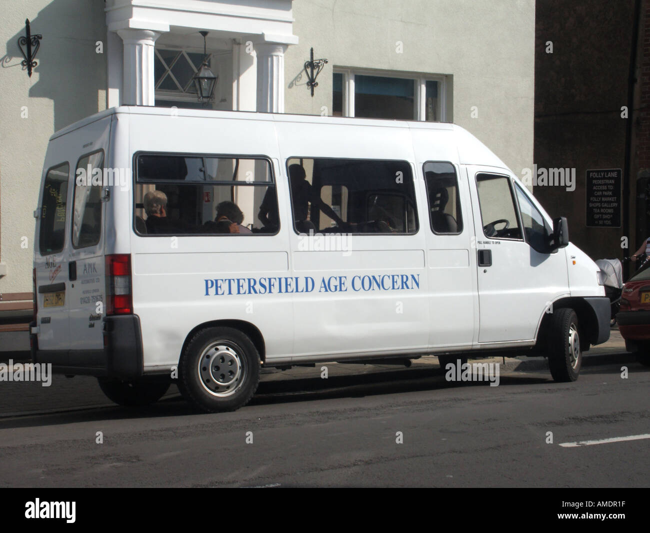 Age Concern charity operating a white mini bus parked close to town ...