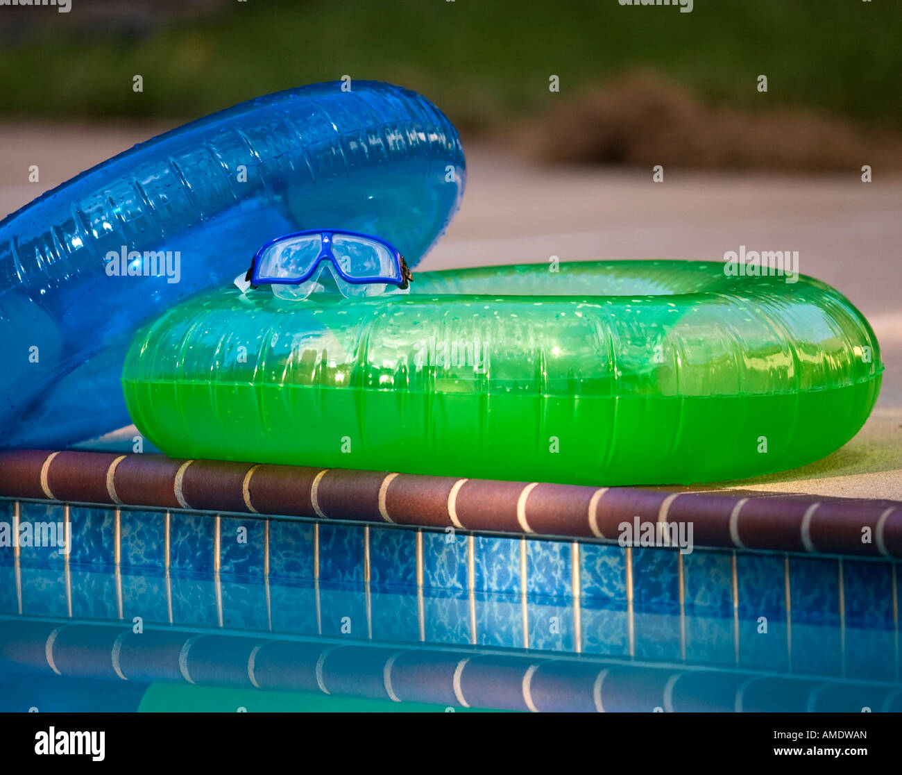 Inflatable ring and goggles by the side of a pool Stock Photo - Alamy