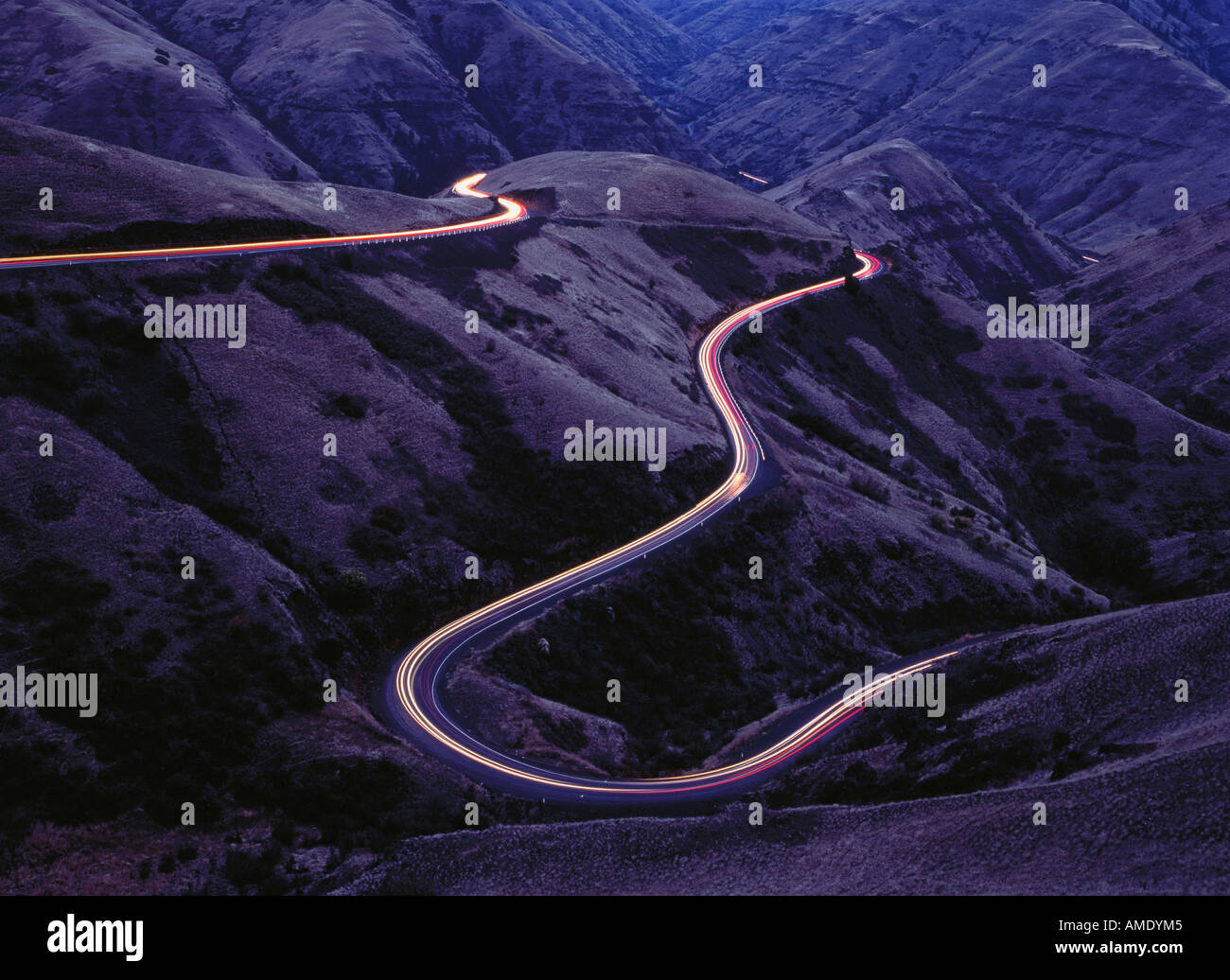 Light trails on curved road at night hi-res stock photography and ...