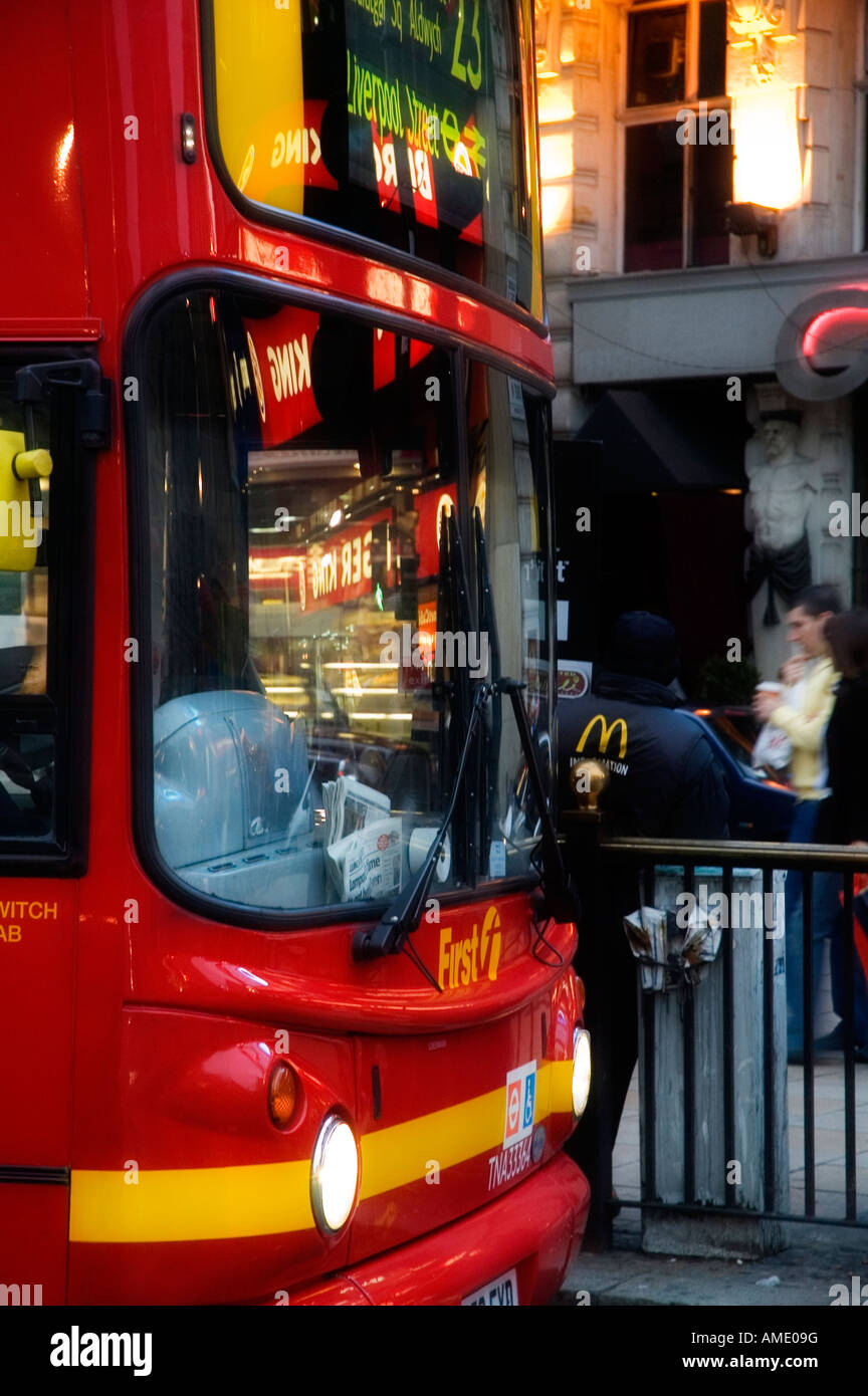 Red London bus with reflections of neon signs in Piccadilly Circus ...