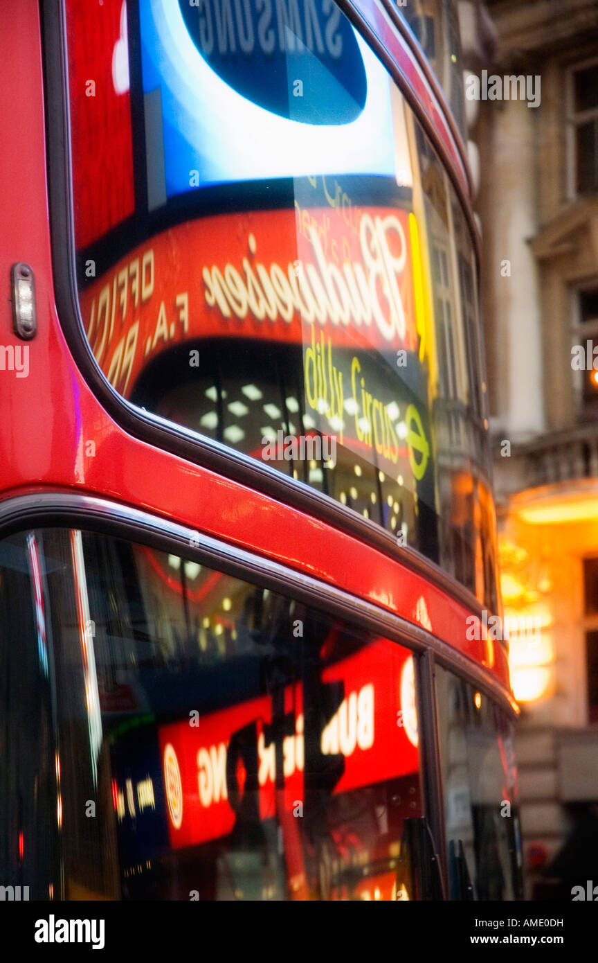 Red London bus with reflections of neon signs in Piccadilly Circus ...