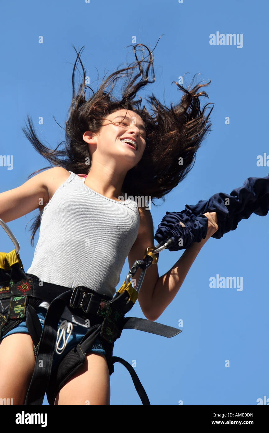 Girl having a good time bungee jumping Stock Photo - Alamy