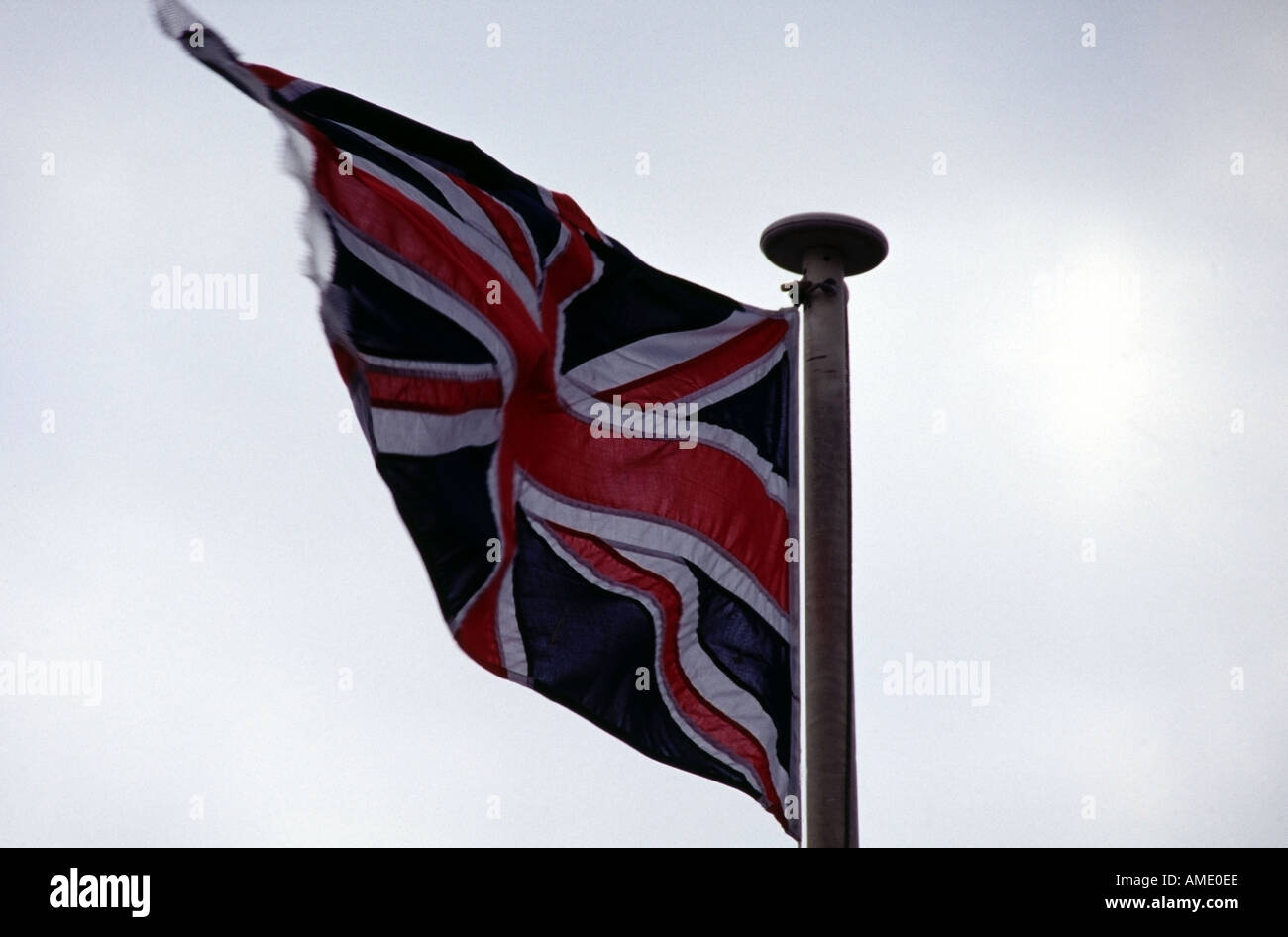 fluttering union jack flag on flag post Stock Photo - Alamy