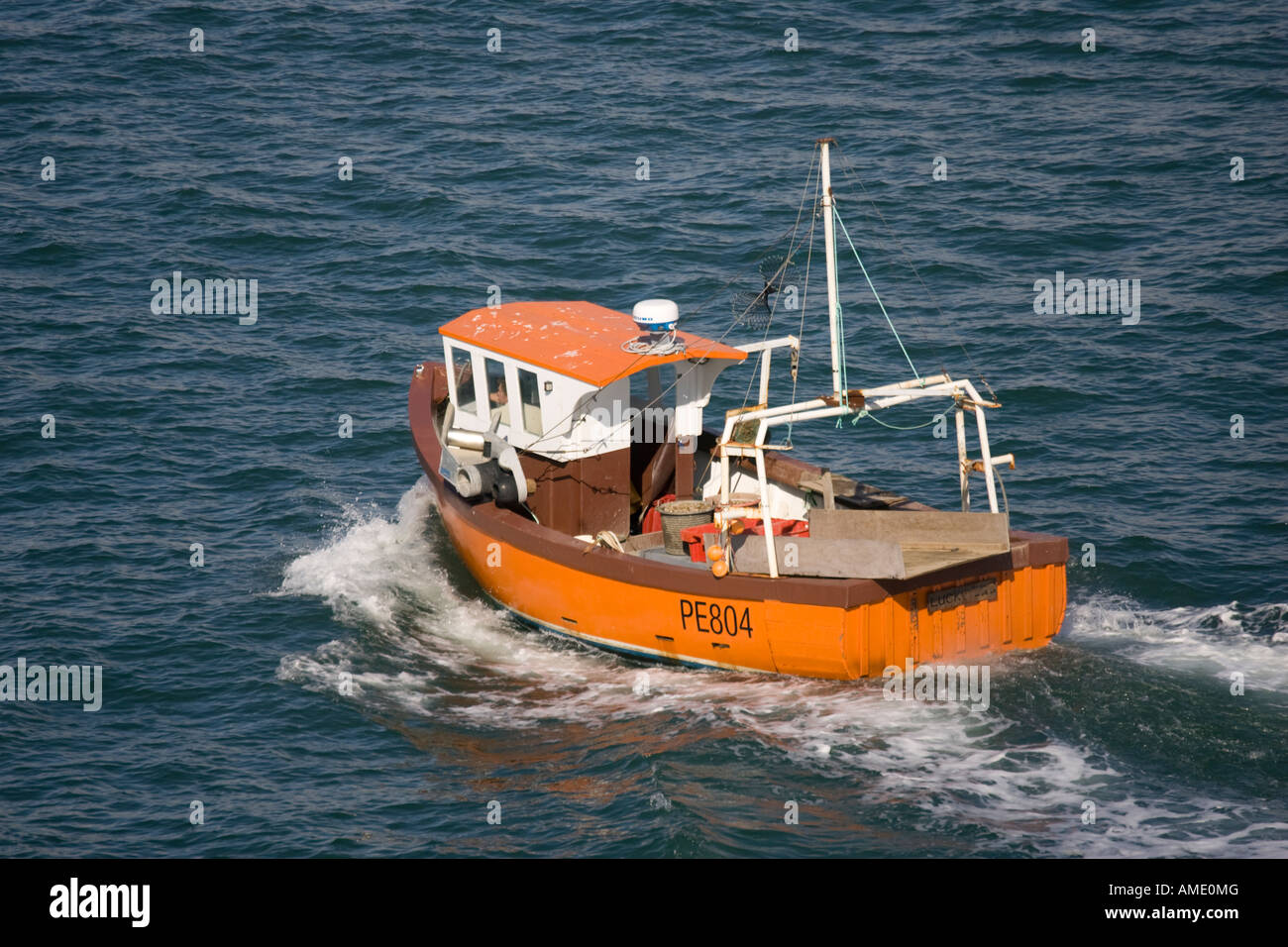 Small orange fishing boat Poole Harbour Dorset UK Stock Photo - Alamy