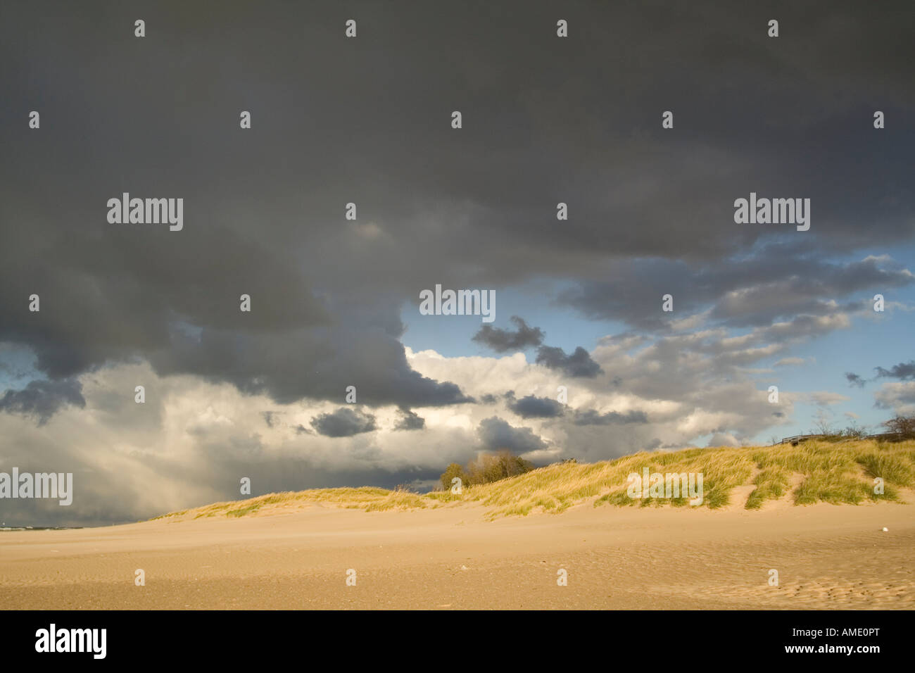 Billowing clouds and blue sky over sandy beach hi-res stock photography ...